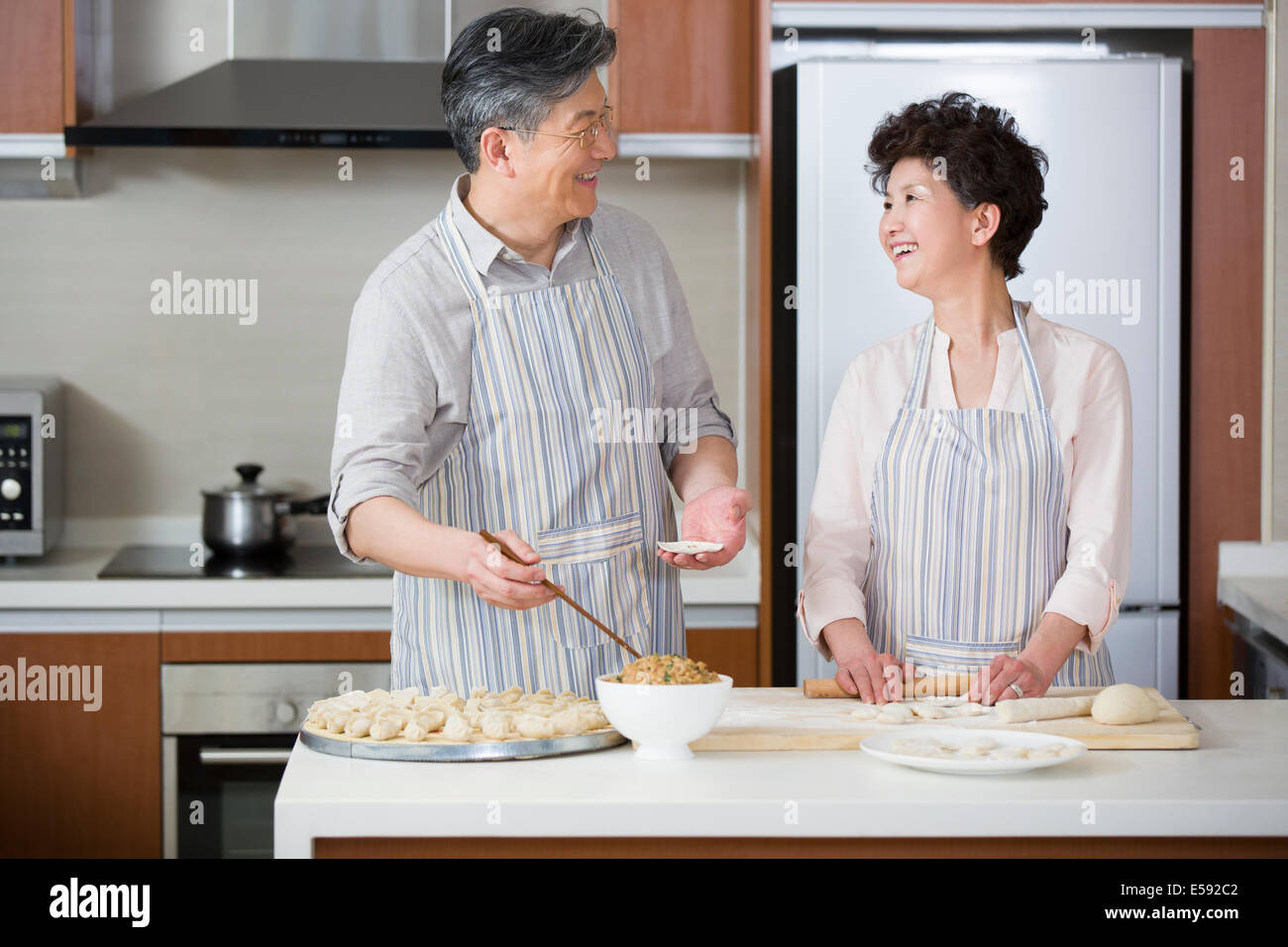 Happy senior couple making dumplings Stock Photo - Alamy