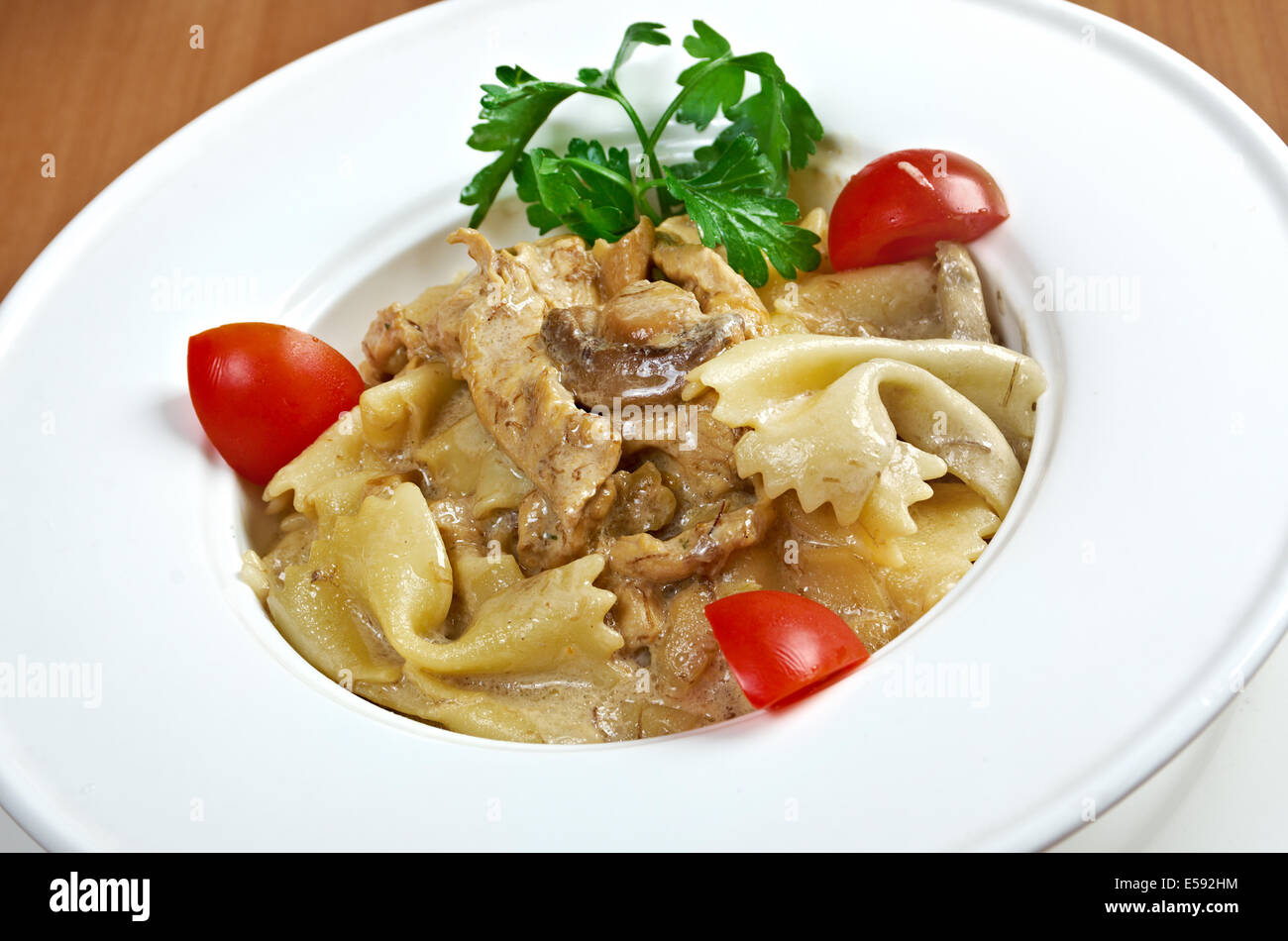 Farfalle pasta with veal and tomatoes Stock Photo - Alamy