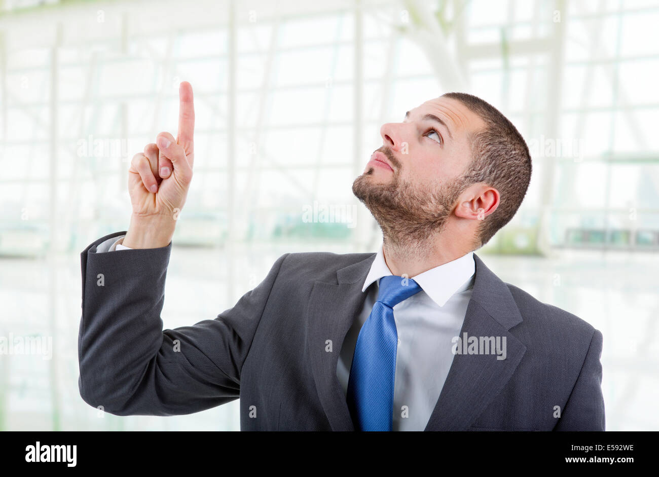 businessman in a suit pointing with his finger at the office Stock ...