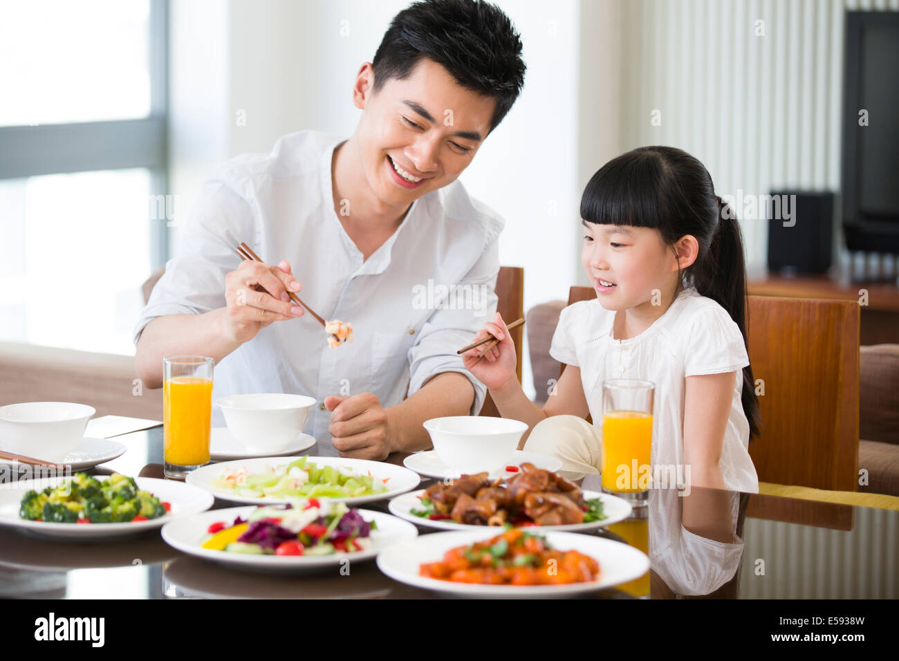 Happy father and daughter having lunch Stock Photo - Alamy