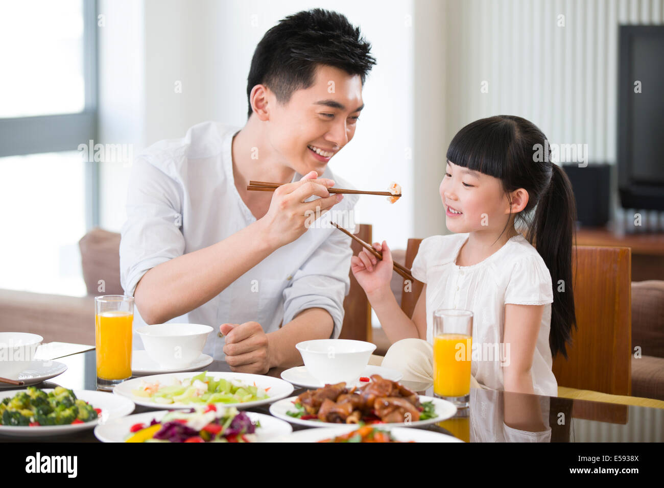 Happy father and daughter having lunch Stock Photo - Alamy