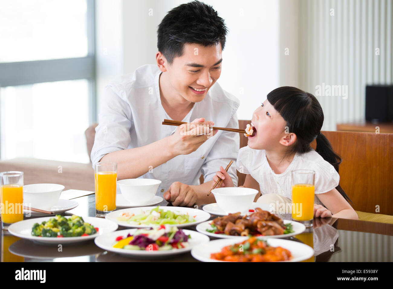 Happy father and daughter having lunch Stock Photo - Alamy