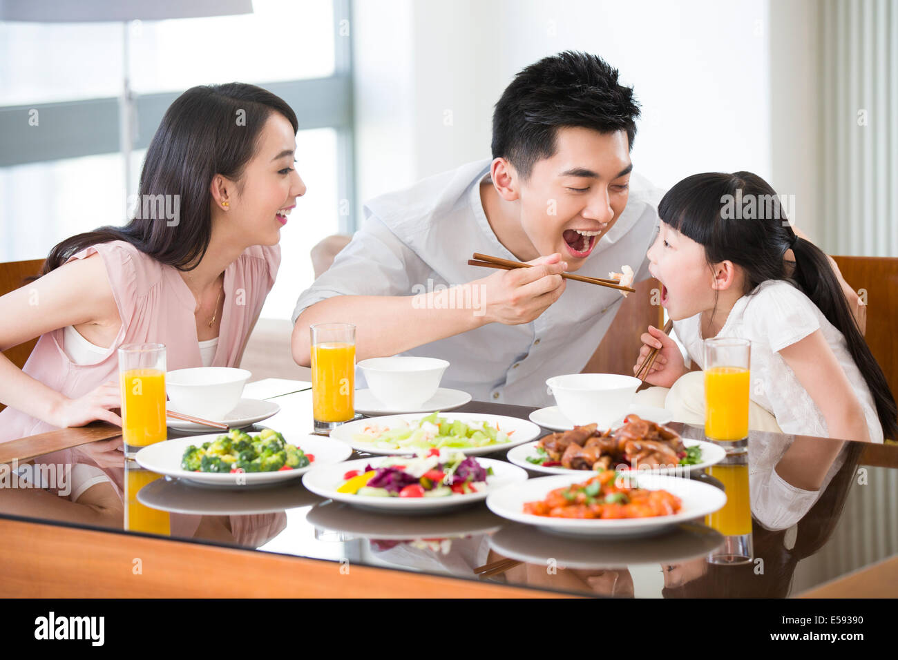 Happy family having lunch Stock Photo - Alamy