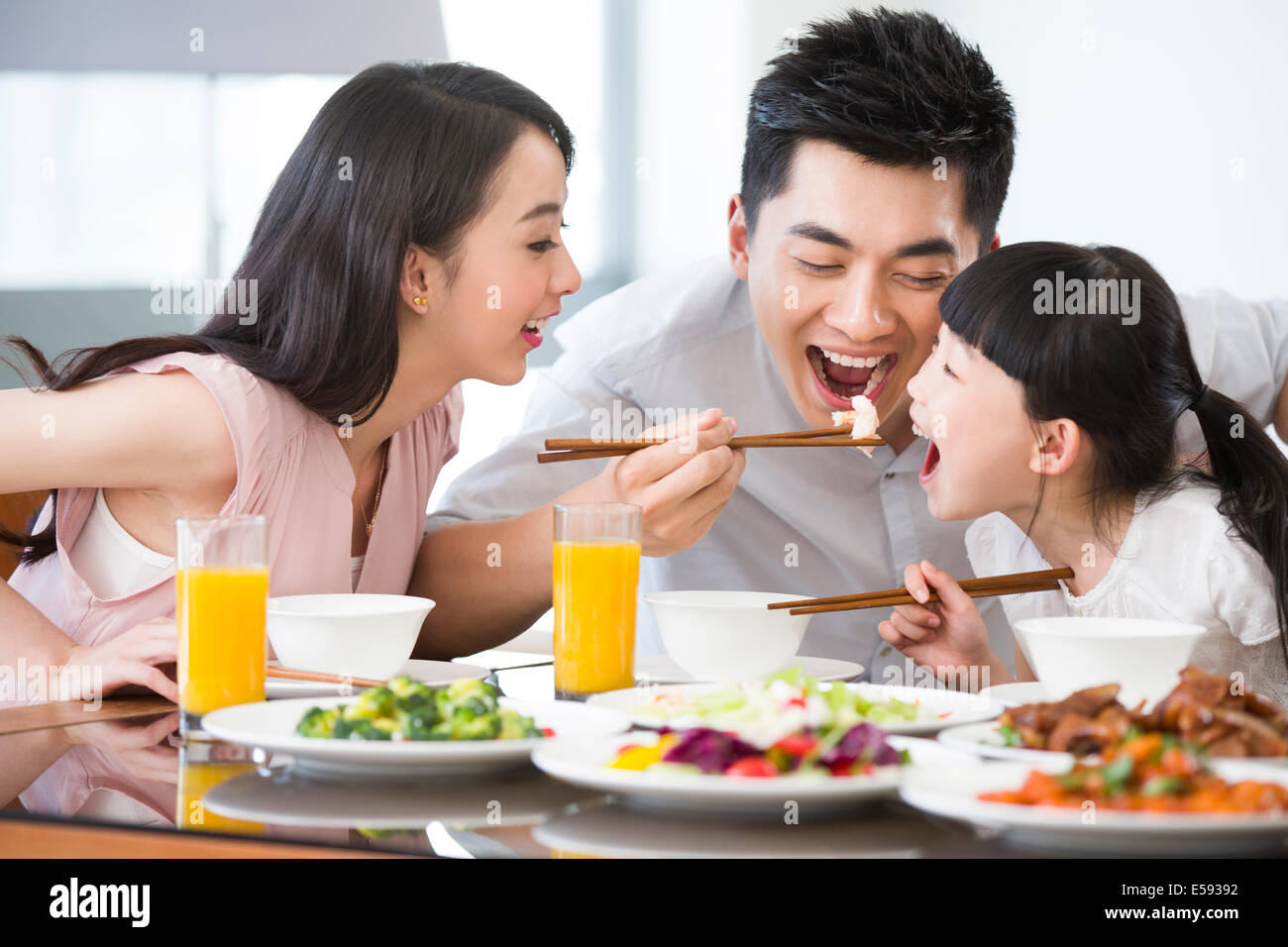 Happy family having lunch Stock Photo - Alamy