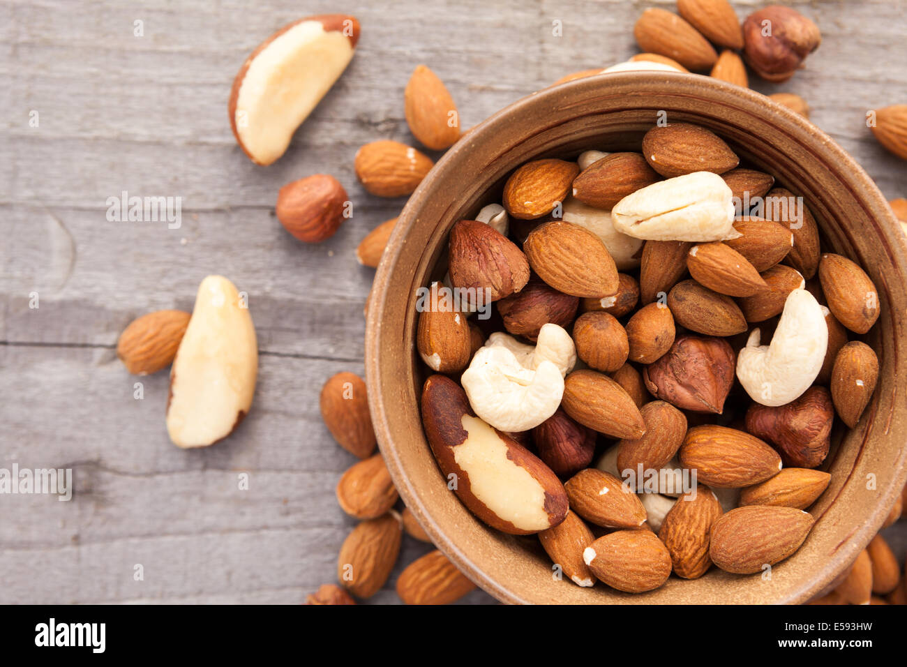 Nuts in bowl and around Stock Photo - Alamy