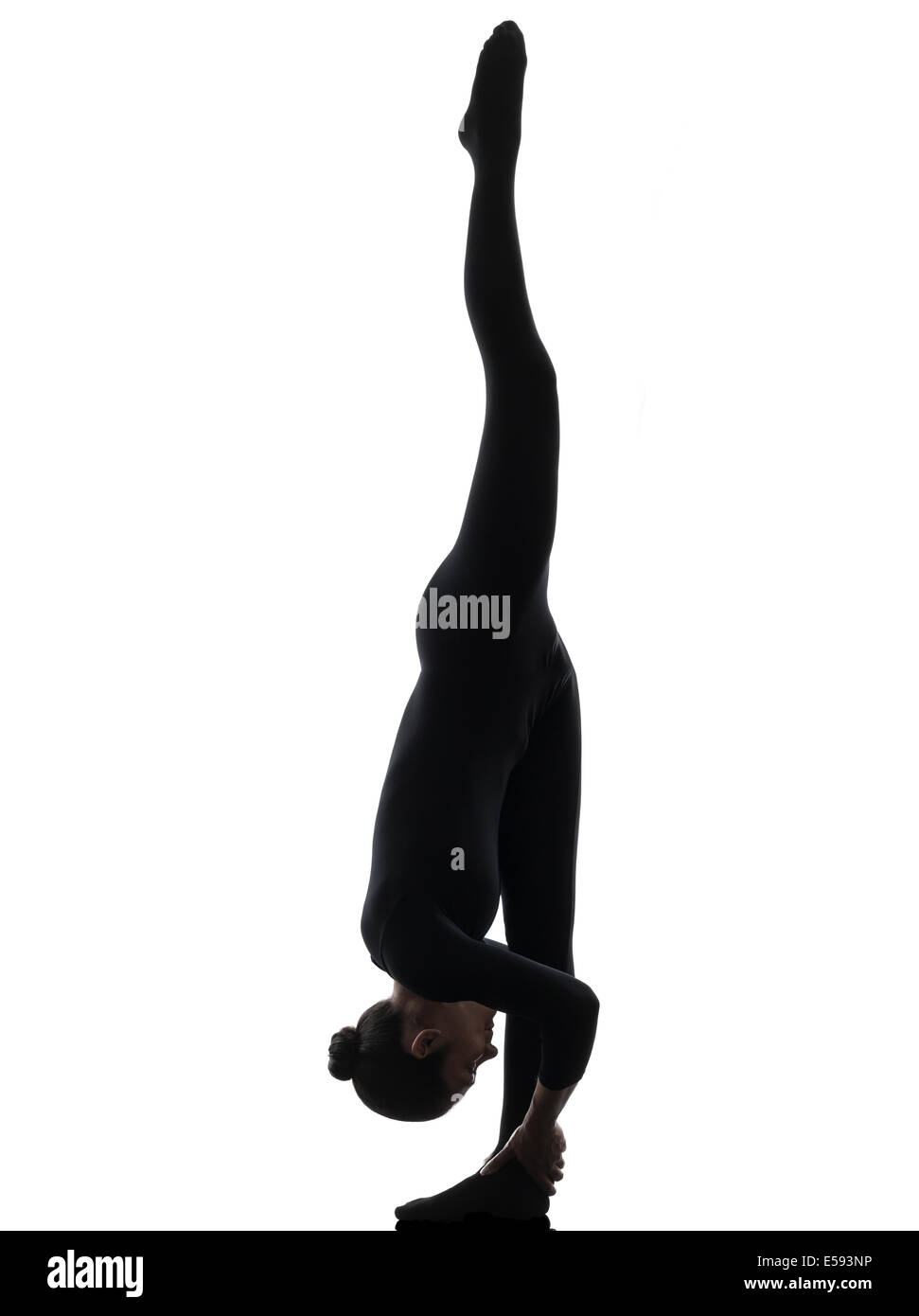 one woman contortionist practicing gymnastic yoga in silhouette on ...