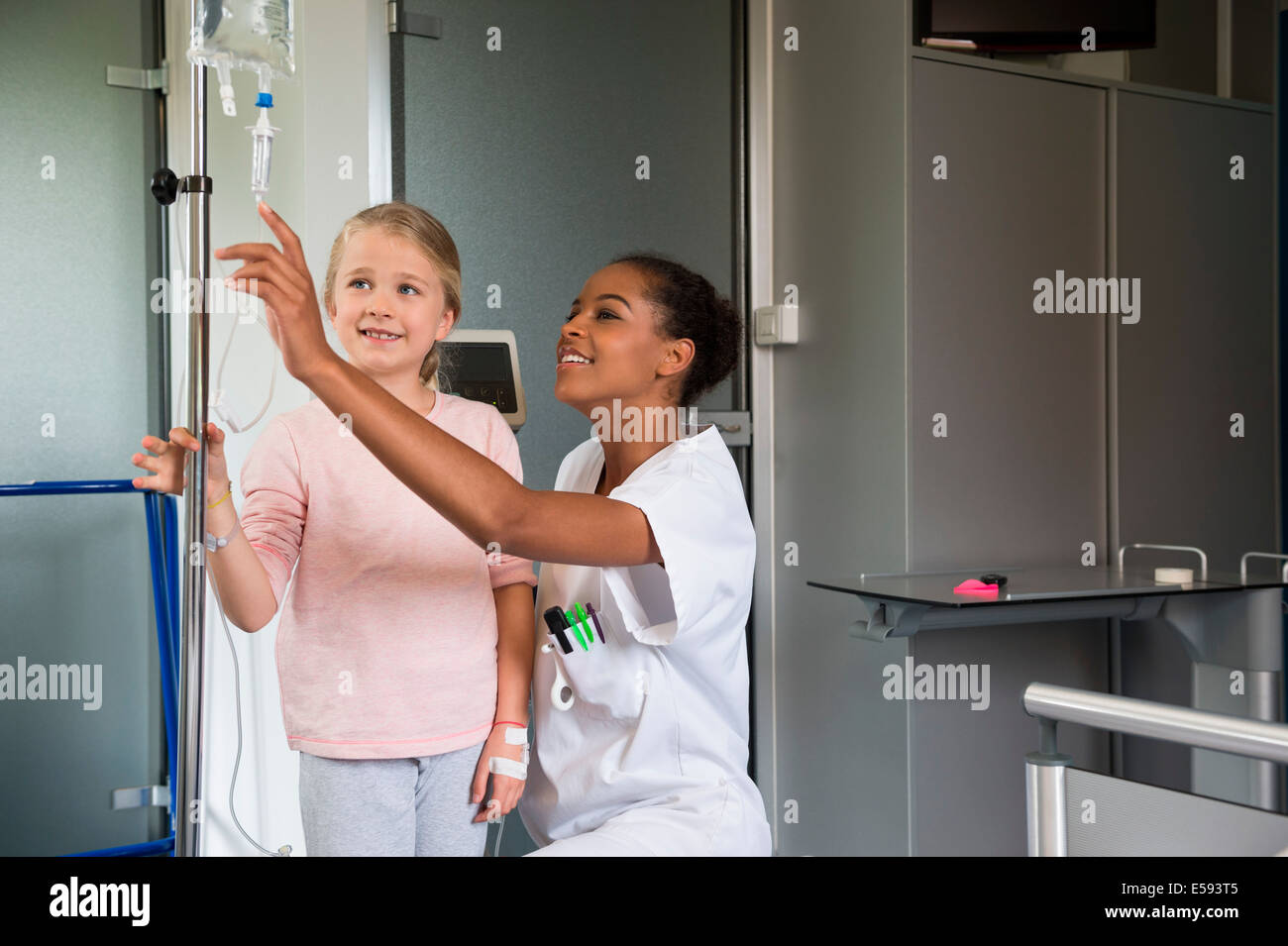 Female nurse assisting to a girl patient in hospital Stock Photo - Alamy