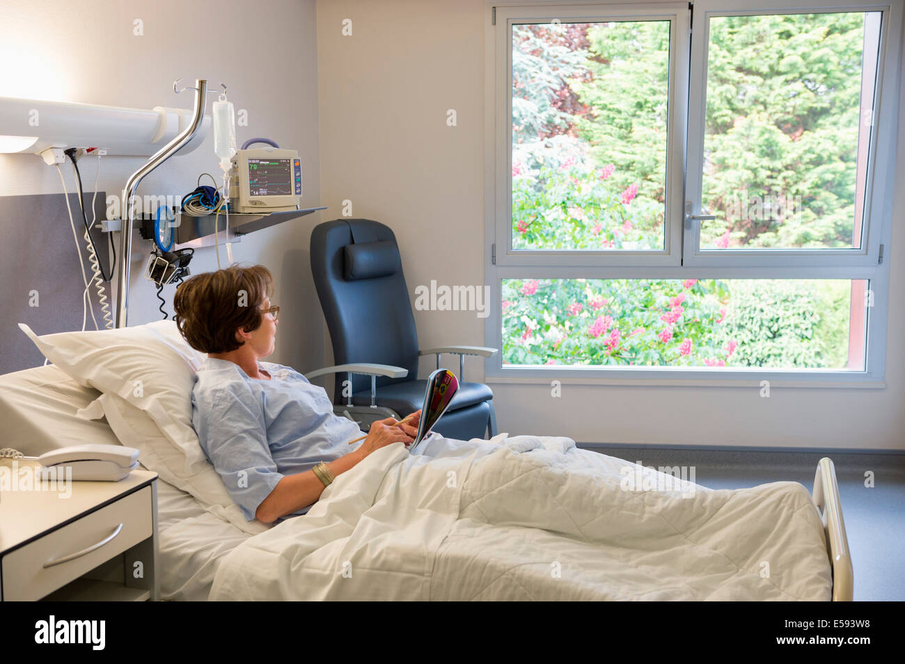 Woman looking through a window on hospital bed Stock Photo - Alamy