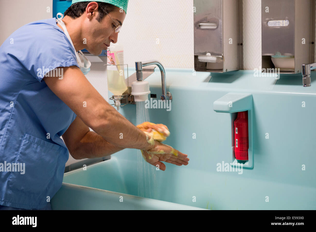 Male surgeon washing hands with disinfectant betadine in operating room ...