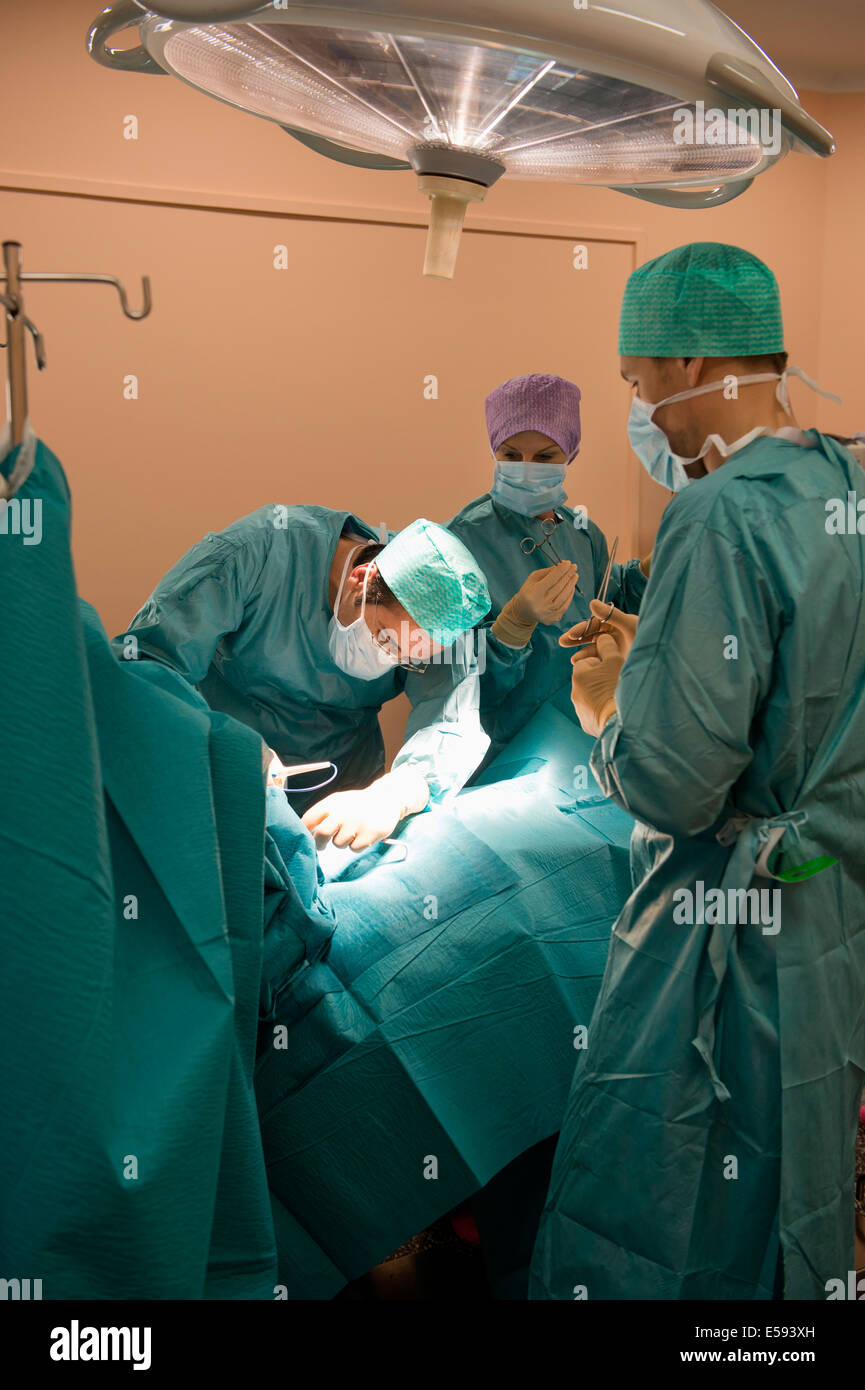 Medical team operating a patient in an operating room Stock Photo - Alamy