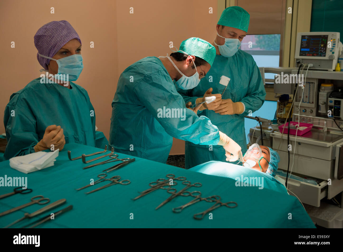 Medical team operating a patient in an operating room Stock Photo - Alamy