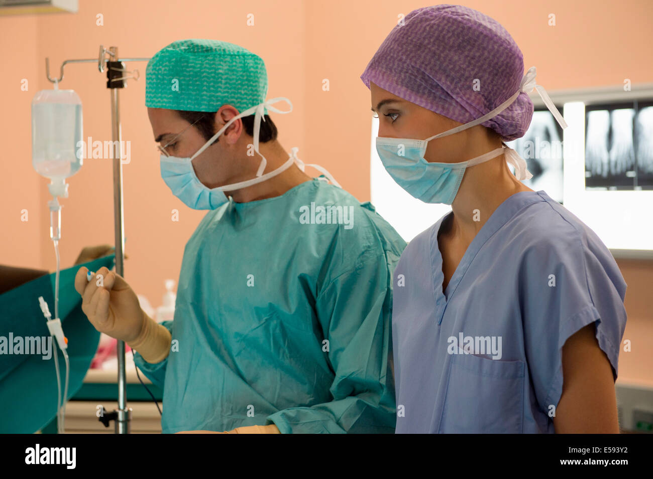 Male surgeon and female nurse in an operating room Stock Photo - Alamy