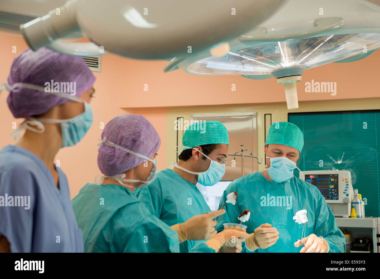 Medical team performing an operation in an operating room Stock Photo ...