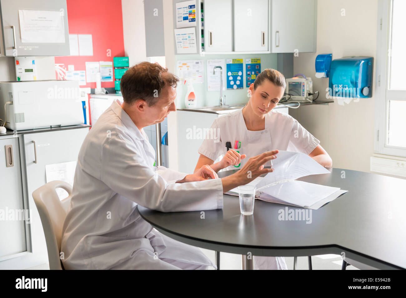 Doctor and nurse analyzing medical record in a hospital Stock Photo - Alamy