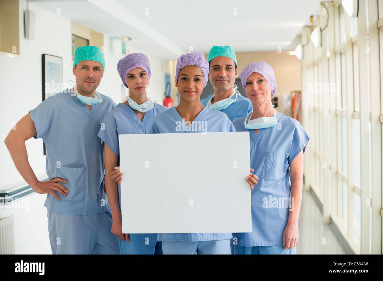 Medical team holding a whiteboard Stock Photo - Alamy