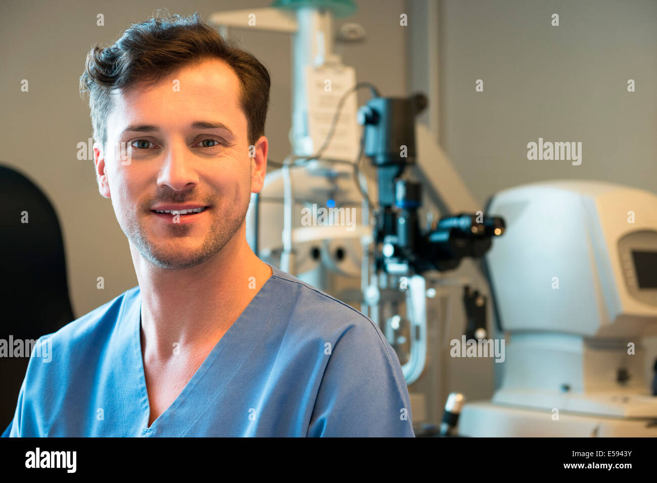 Male doctor with eye test equipment Stock Photo - Alamy