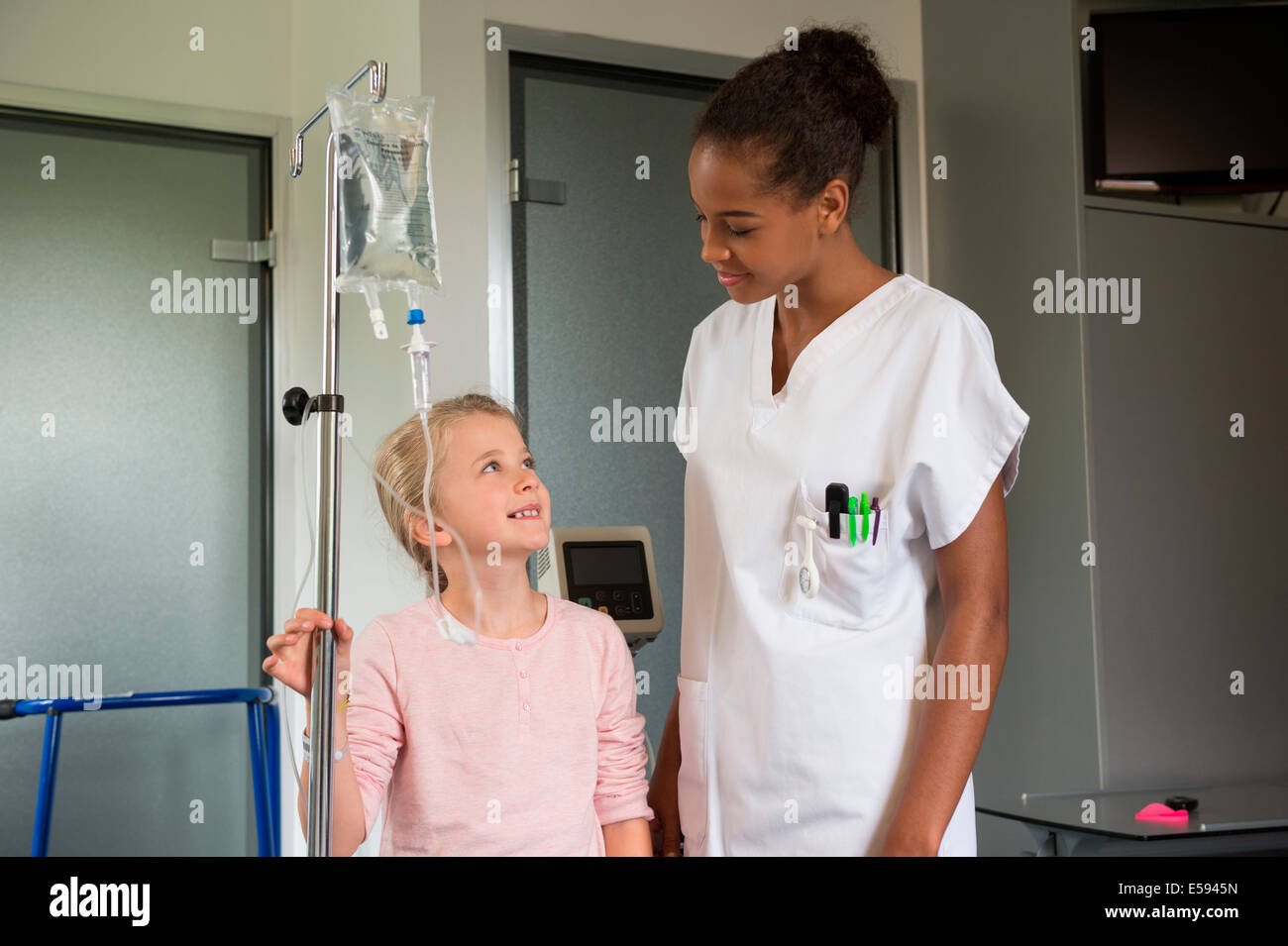 Female nurse assisting to a girl patient in hospital Stock Photo - Alamy