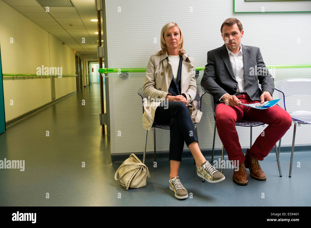 Couple sitting in the waiting area of a hospital Stock Photo - Alamy