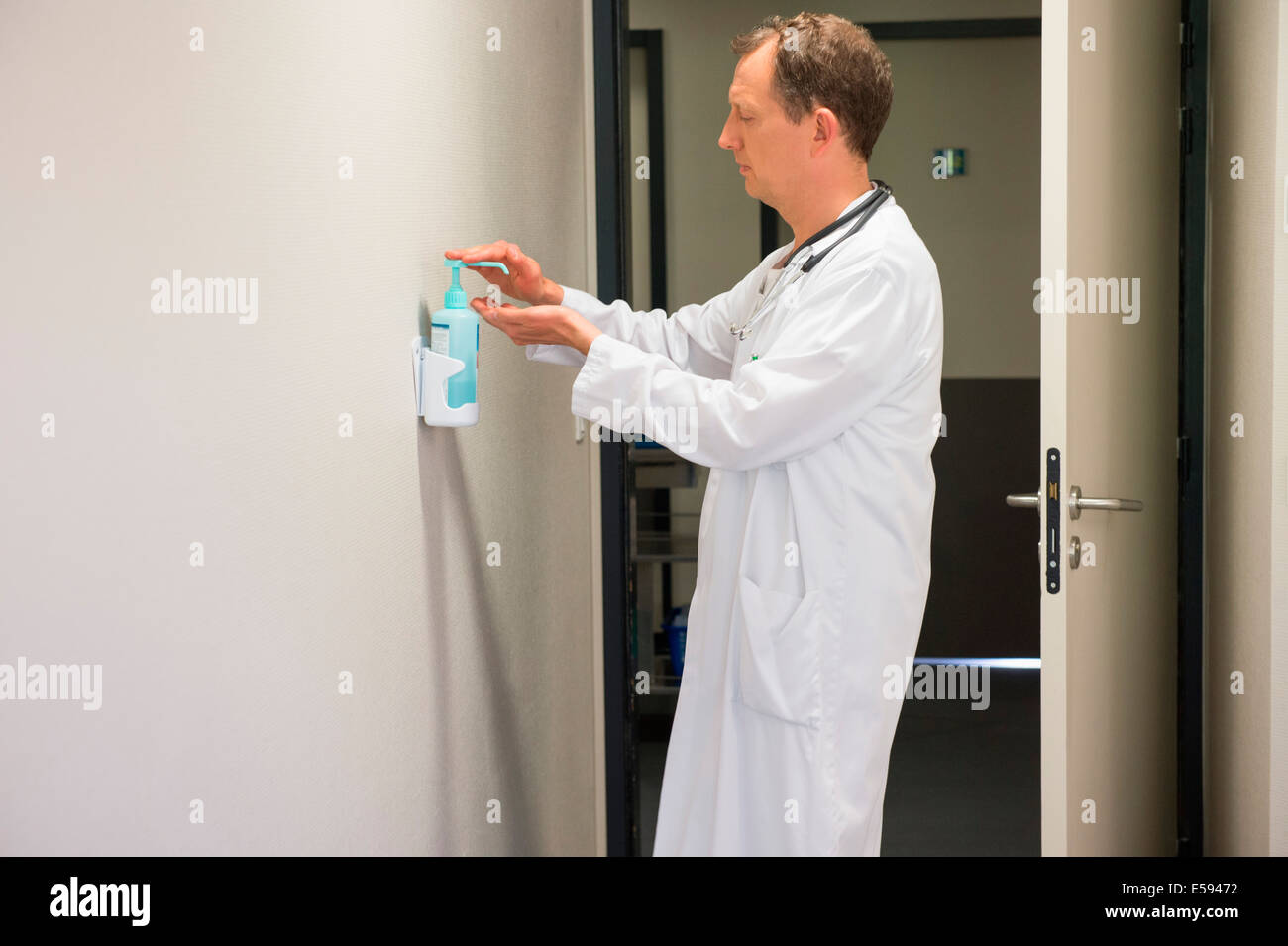 Male doctor using hygiene hand wash in hospital room Stock Photo - Alamy