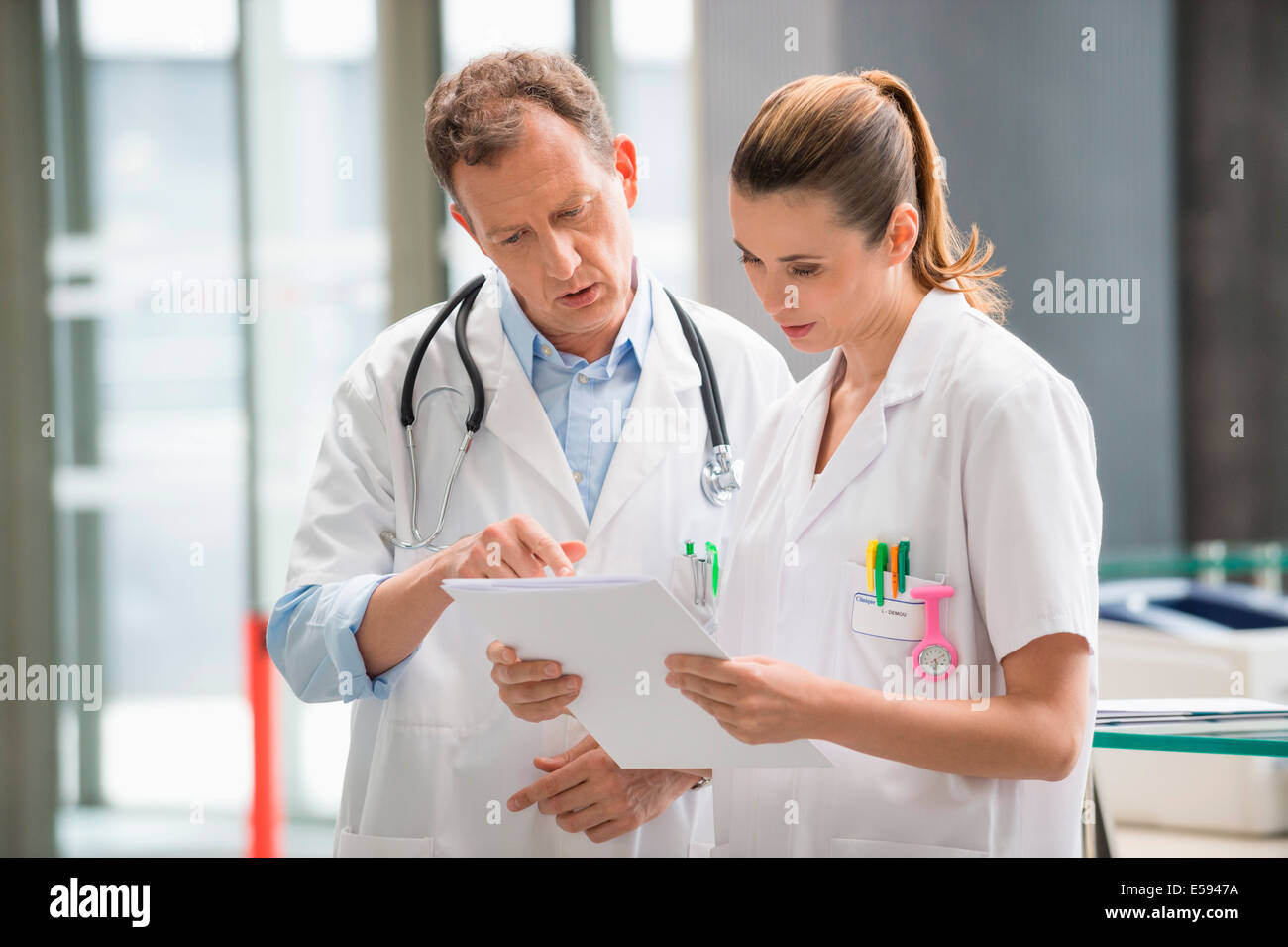 Two doctors discussing medical report in hospital Stock Photo - Alamy Two doctors discussing medical report in hospital Stock Photo - Alamy
