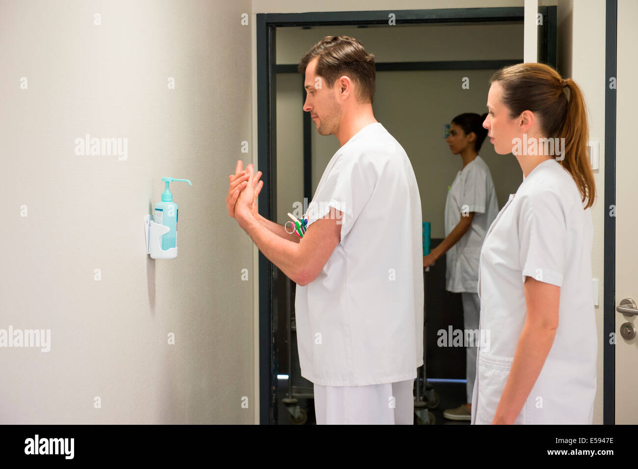 Male doctor using hygiene hand wash in hospital room Stock Photo - Alamy