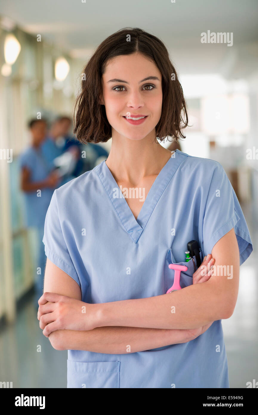 Portrait of a female nurse standing with her arms crossed Stock Photo ...