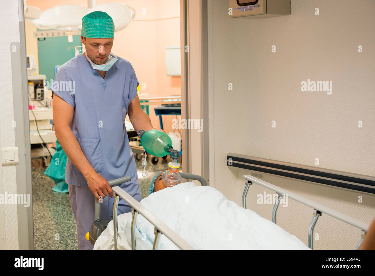 Surgeon moving patient into operating room Stock Photo - Alamy