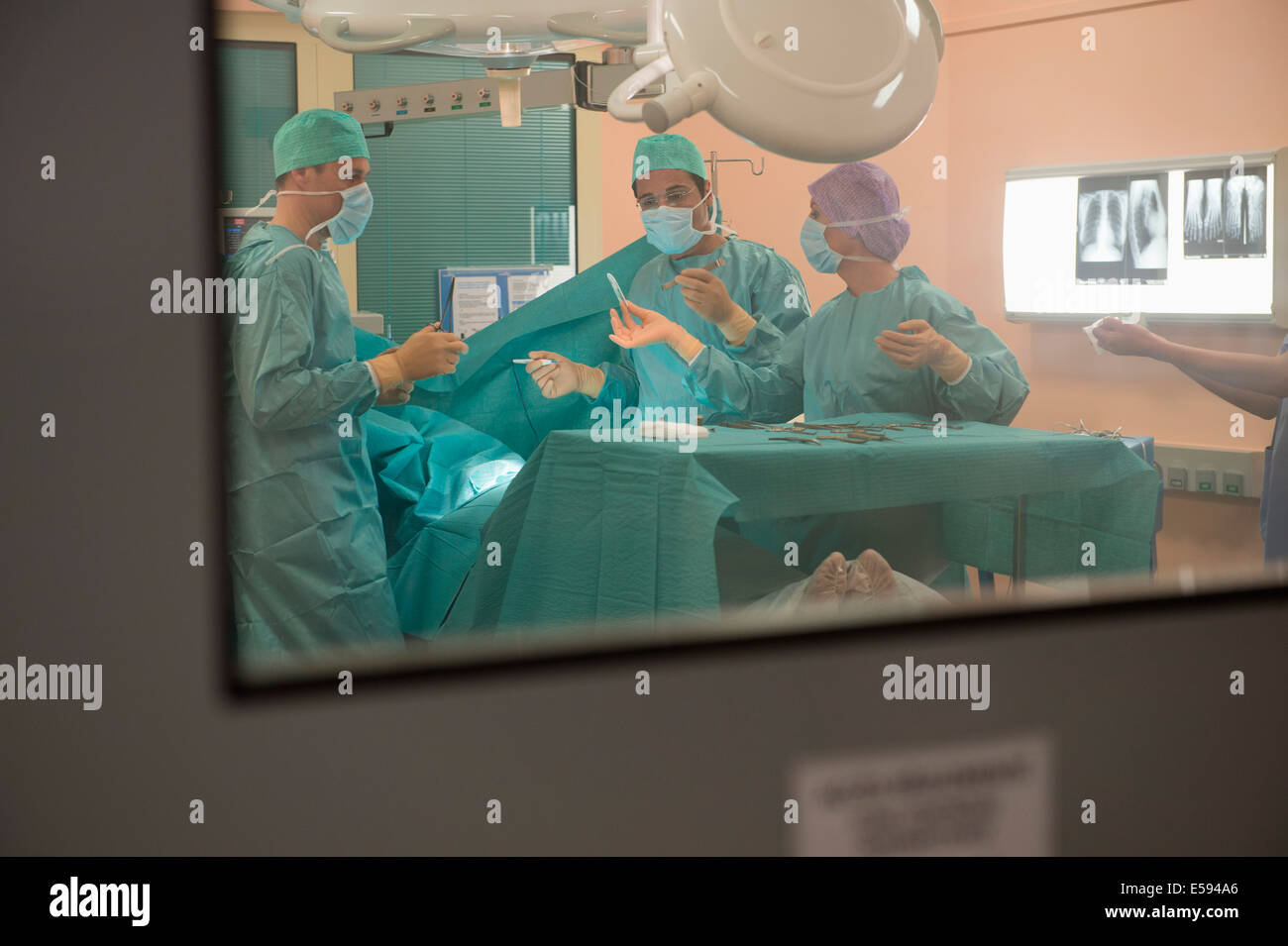 Medical team operating a patient in an operating room Stock Photo - Alamy