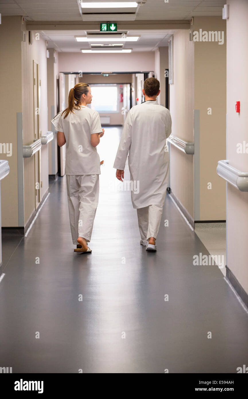 Rear view of doctors walking in the corridor of a hospital Stock Photo ...