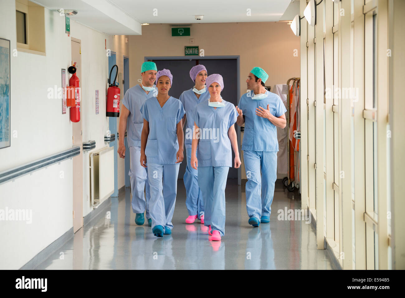 Medical team walking in the corridor of a hospital Stock Photo - Alamy