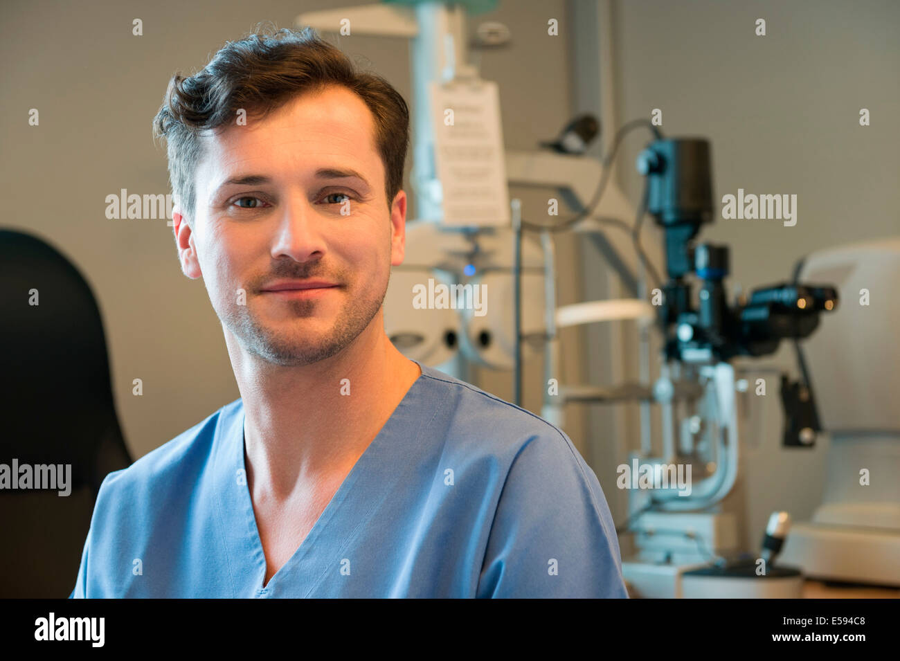 Male doctor with eye test equipment Stock Photo - Alamy