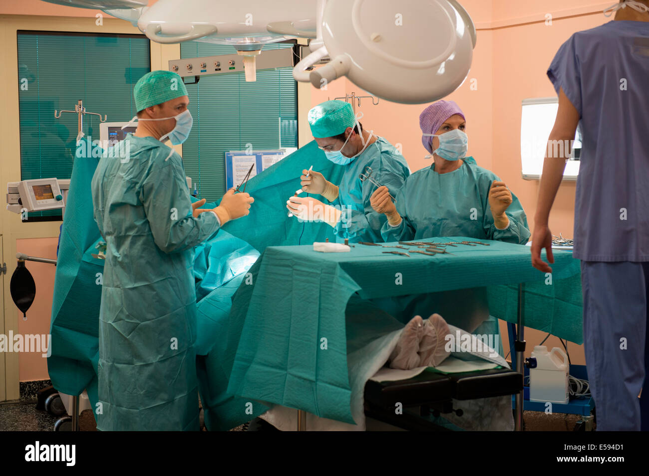 Medical team operating a patient in an operating room Stock Photo - Alamy