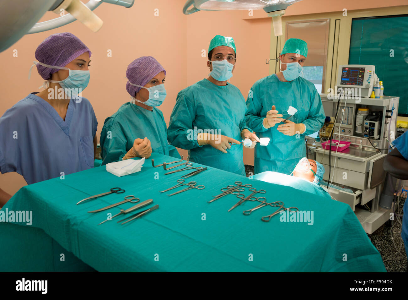 Medical team operating a patient in an operating room Stock Photo - Alamy