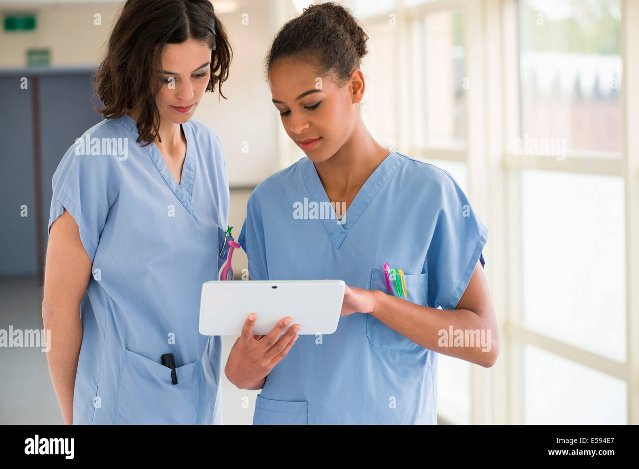 Female nurses watching clip on a digital tablet Stock Photo - Alamy