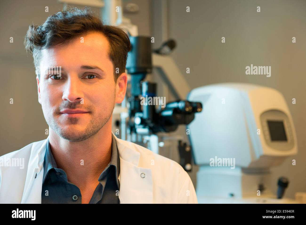 Portrait of male doctor with eye test equipment Stock Photo - Alamy