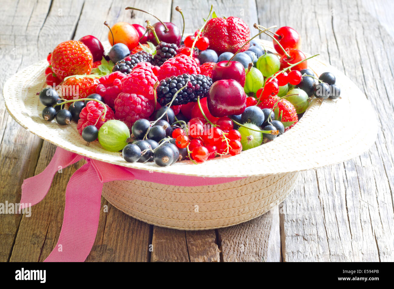Summer wild berry fruits on vintage board still life concept Stock ...