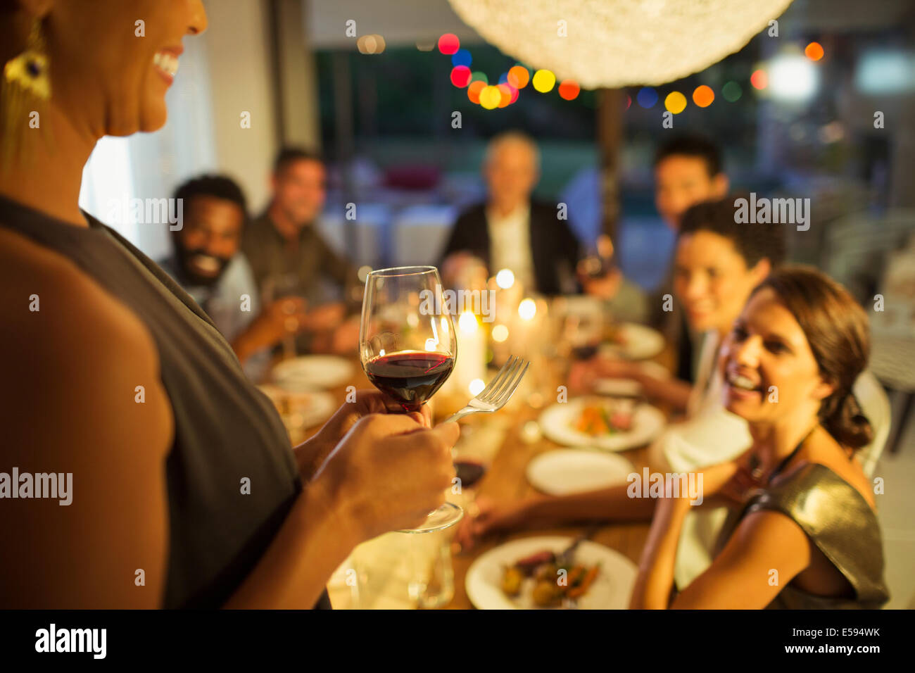 Woman proposing a toast at party Stock Photo - Alamy