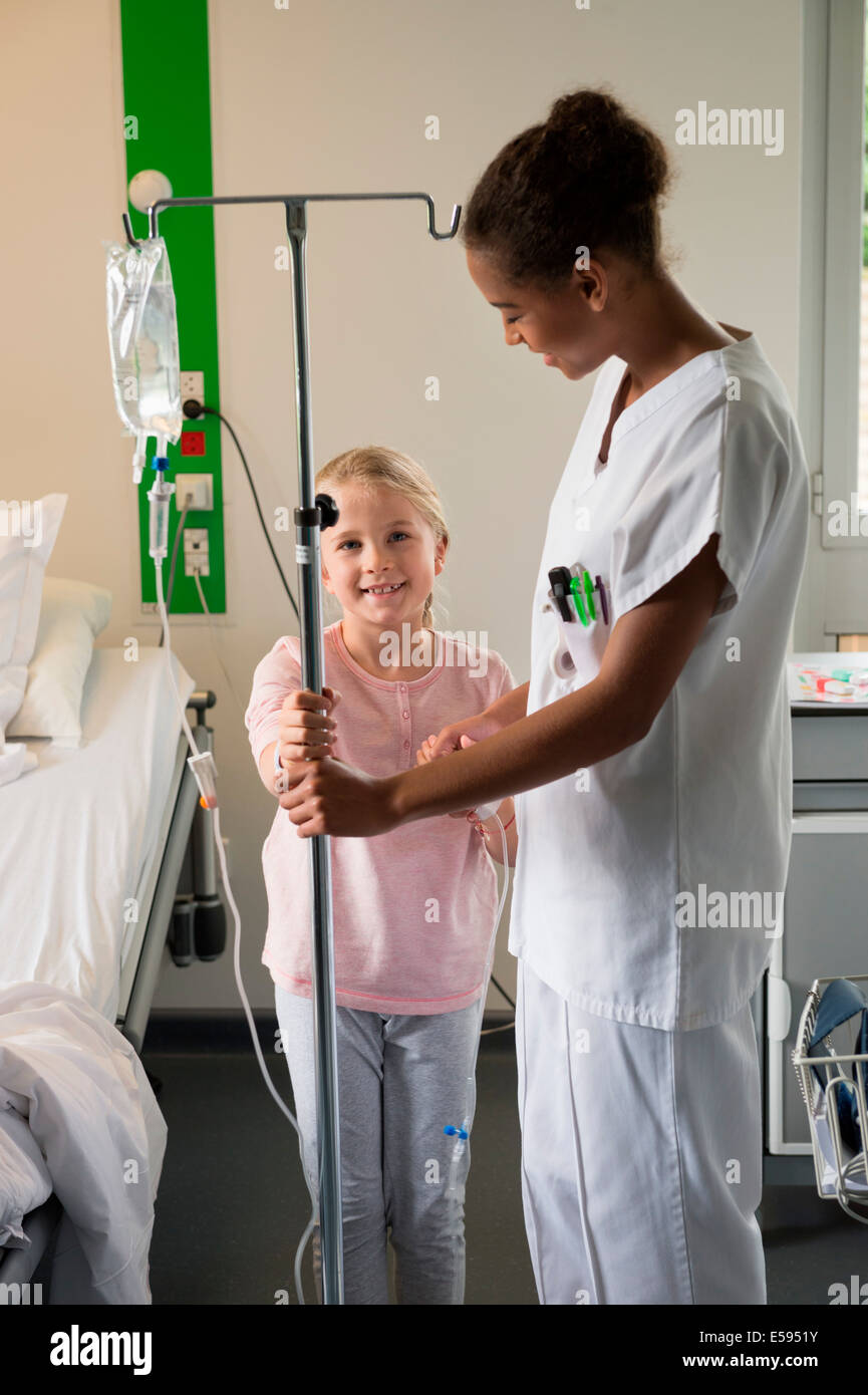 Female nurse assisting to a girl patient in hospital Stock Photo - Alamy