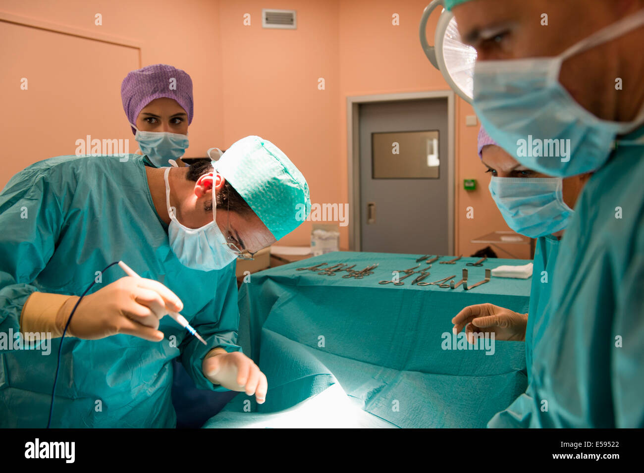 Medical team operating a patient in an operating room Stock Photo - Alamy