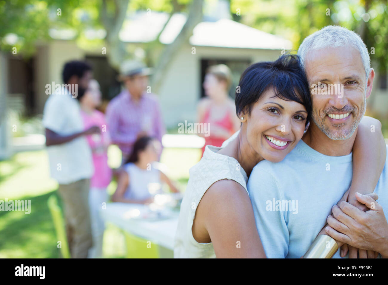 Couple hugging at party Stock Photo - Alamy