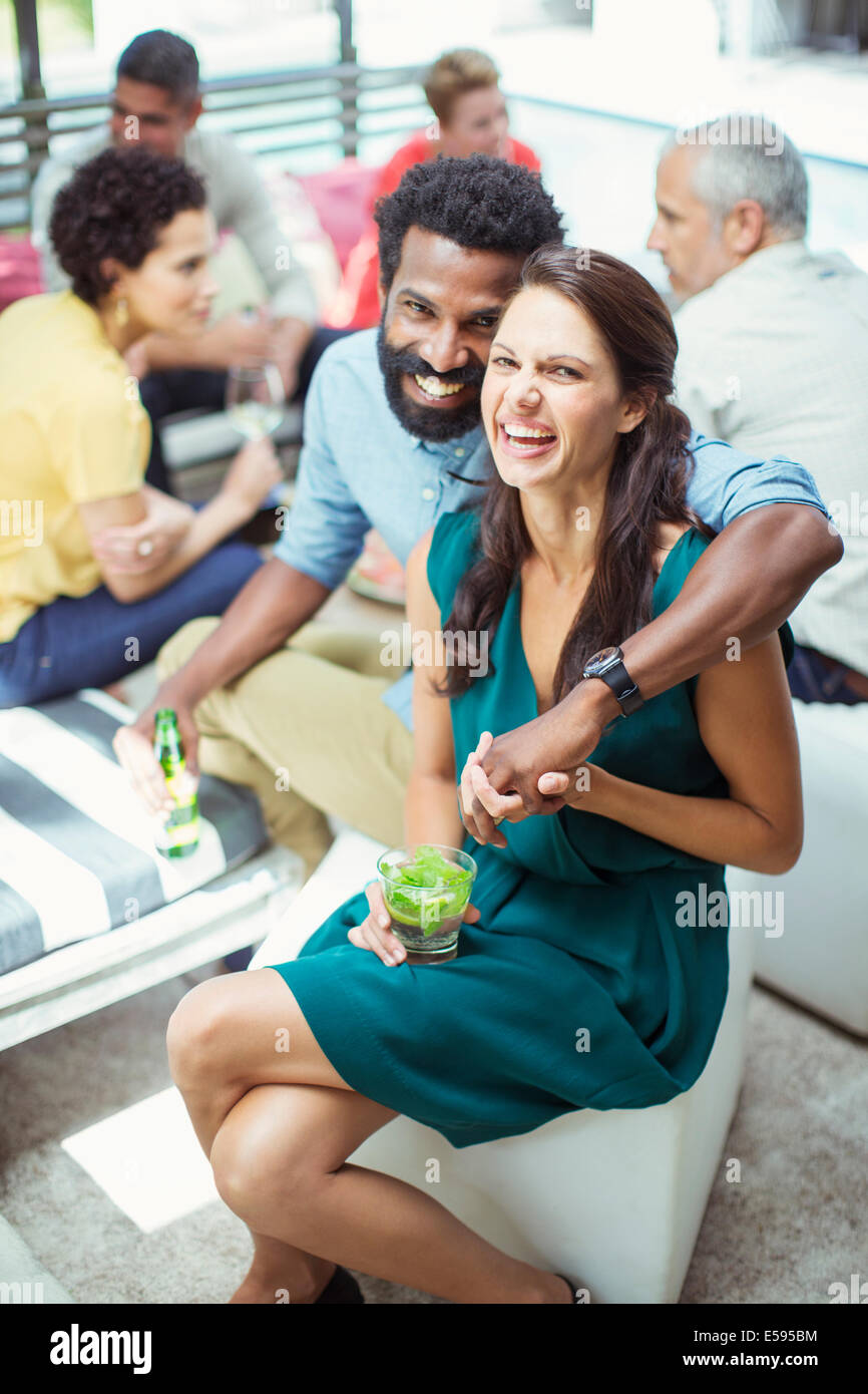 Couple hugging at party Stock Photo - Alamy