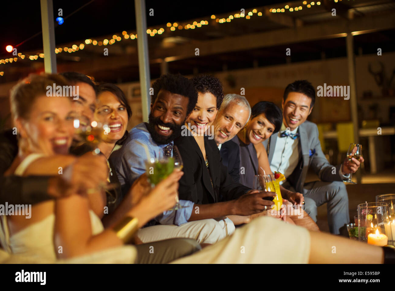 Friends smiling together at party Stock Photo - Alamy