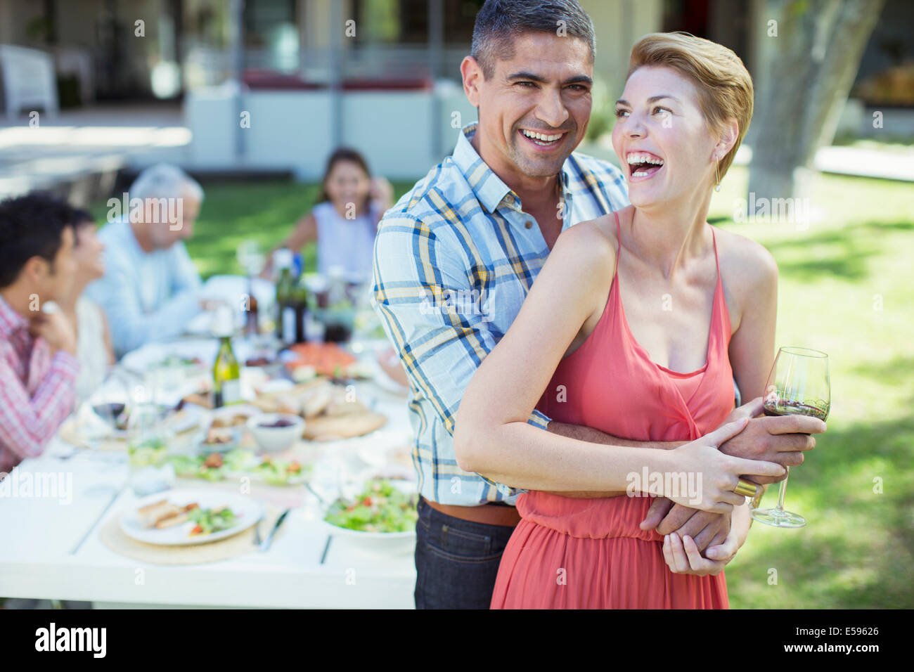Laughing couple hugging outdoors Stock Photo - Alamy