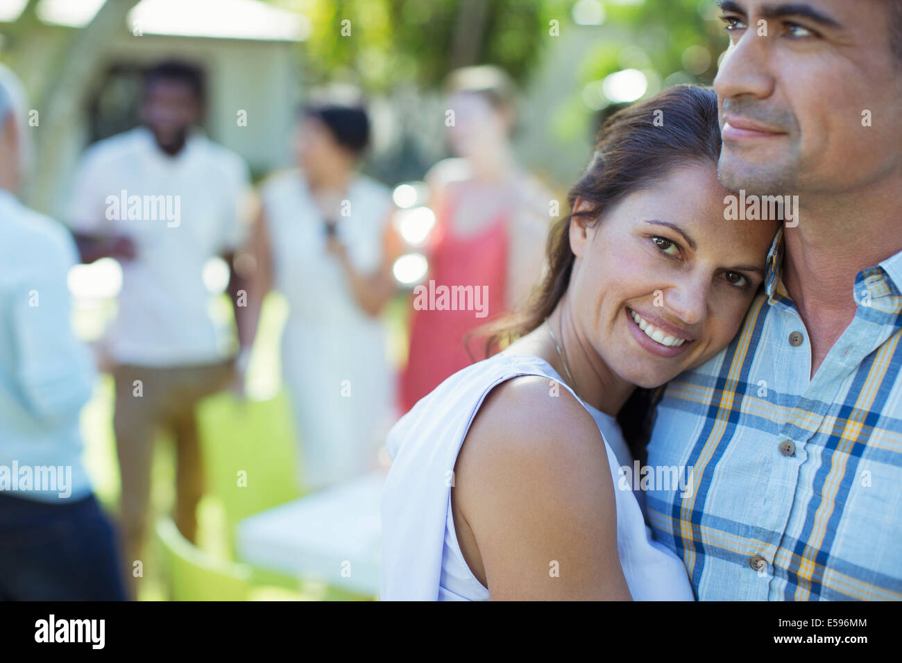 Couple hugging at dinner party Stock Photo - Alamy