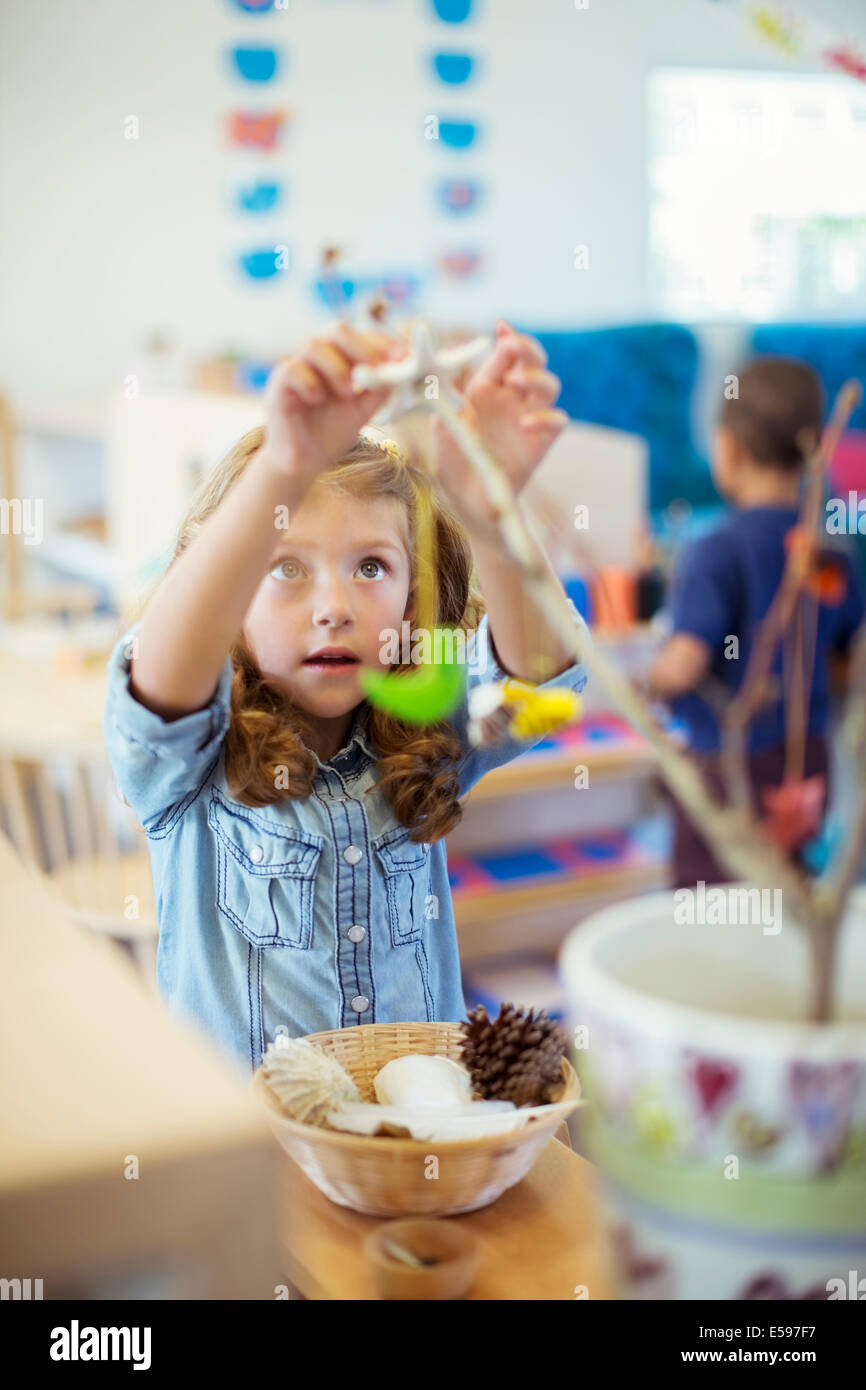 Student playing with model in classroom Stock Photo - Alamy