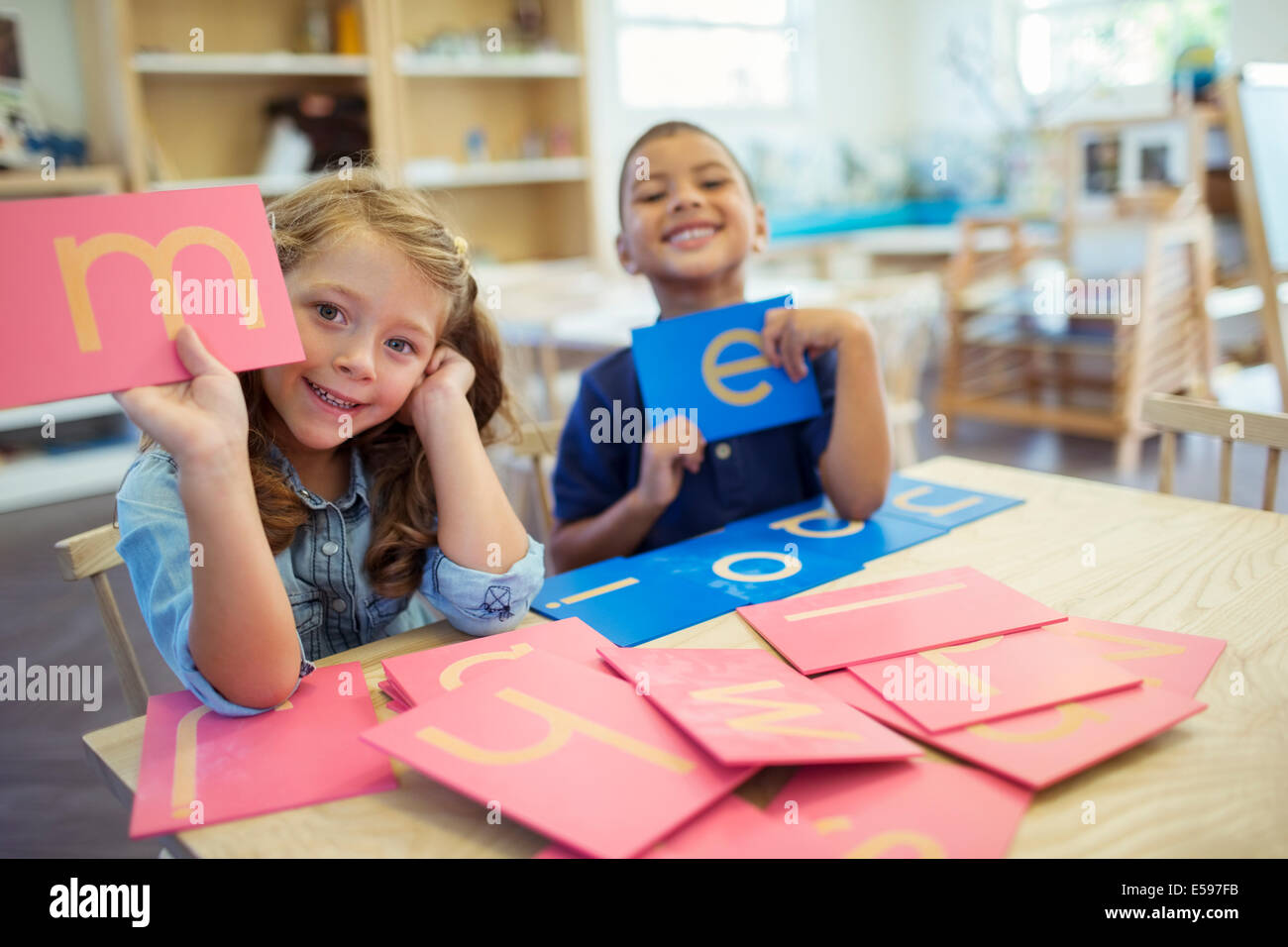 Students holding letters in classroom Stock Photo - Alamy