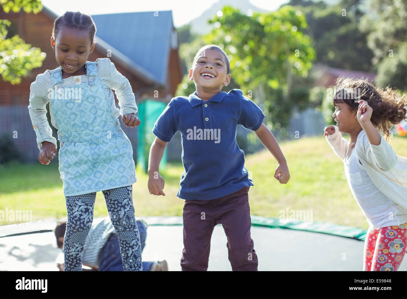 Children jumping on trampoline outdoors Stock Photo - Alamy