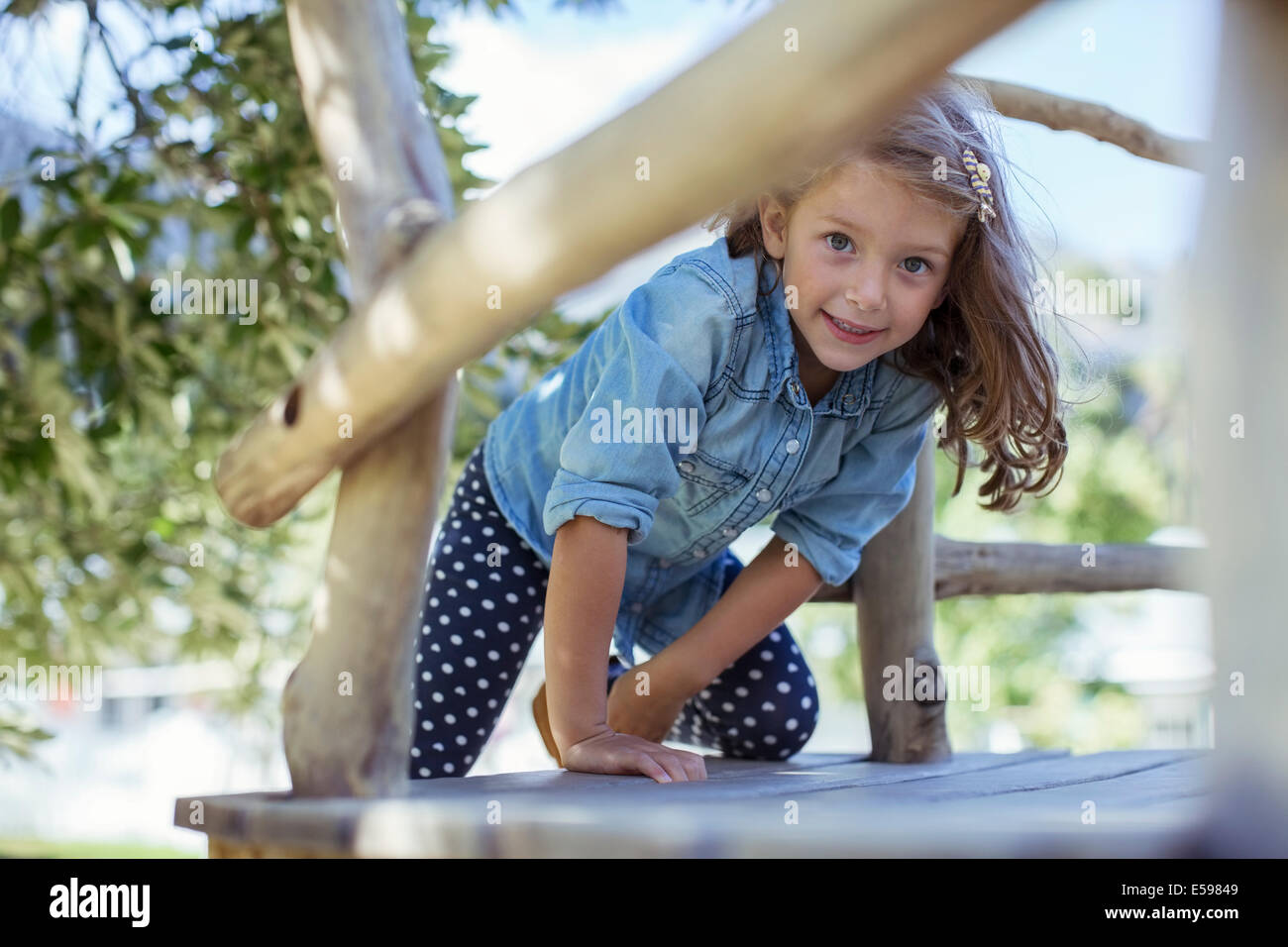 Girl climbing in treehouse outdoors Stock Photo - Alamy