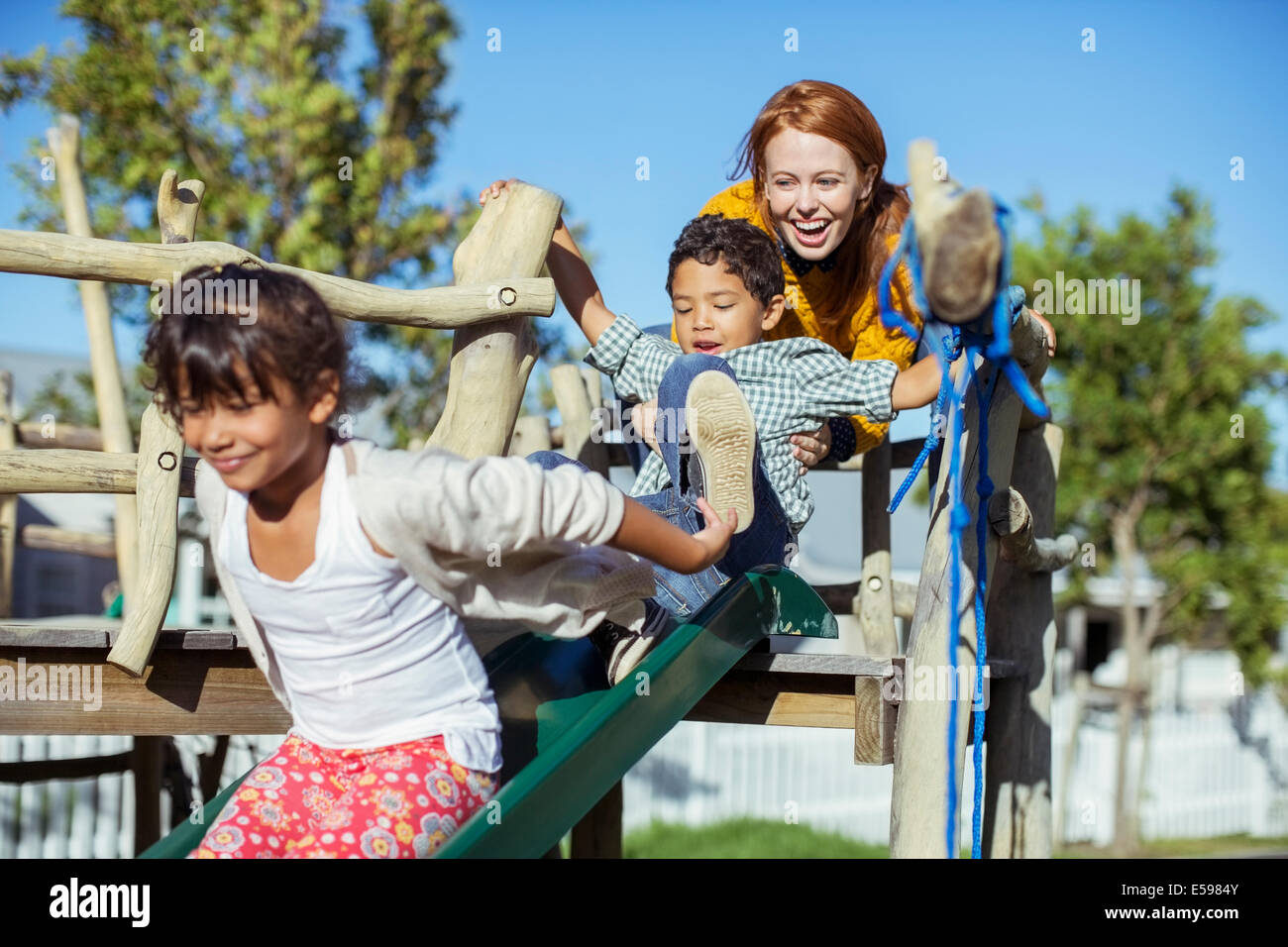 Teacher and students playing on playground Stock Photo - Alamy