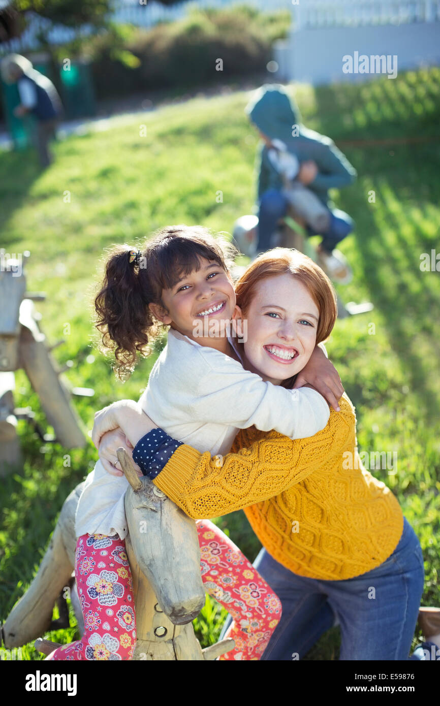 Student and teacher hugging outdoors Stock Photo - Alamy